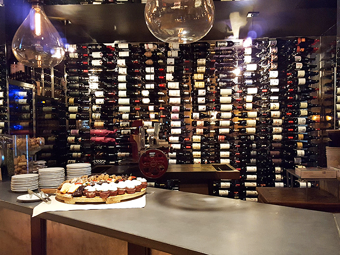 Wine bottles standing at attention like soldiers guarding flavor – an impressive arsenal against the forces of sobriety.