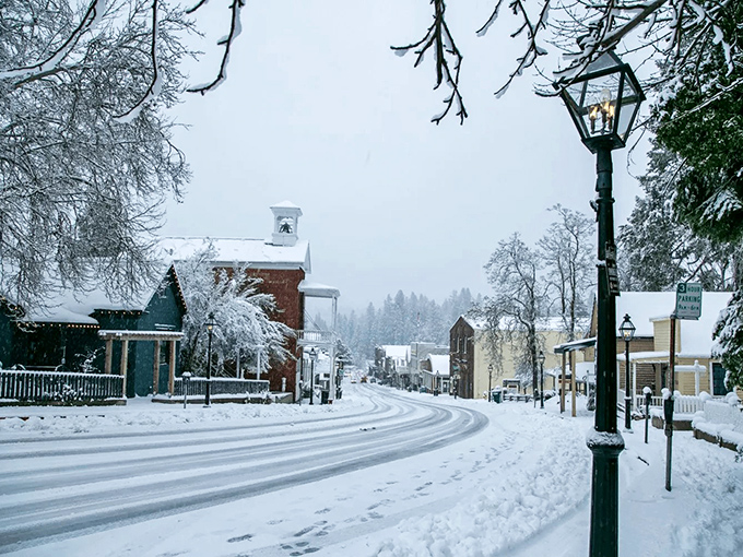 Winter transforms Broad Street into a Currier and Ives print, where gas lamps glow against freshly fallen snow in this Sierra Nevada gem.