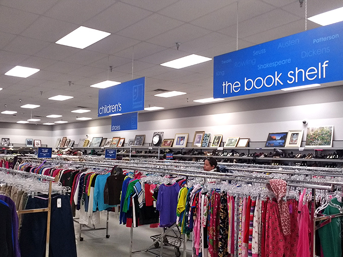 The book shelf sign hovers above a rainbow of clothing options, proving that Goodwill's organization system rivals any department store.