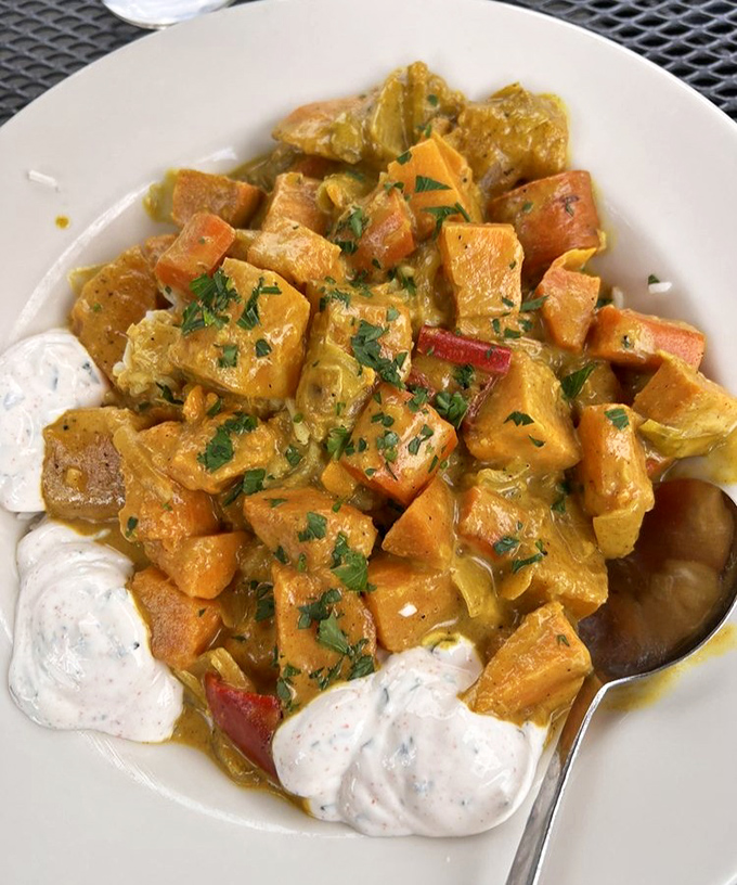 The coconut curry transforms sweet potatoes and vegetables into a vibrant, aromatic journey that makes you wonder why you'd ever need meat.