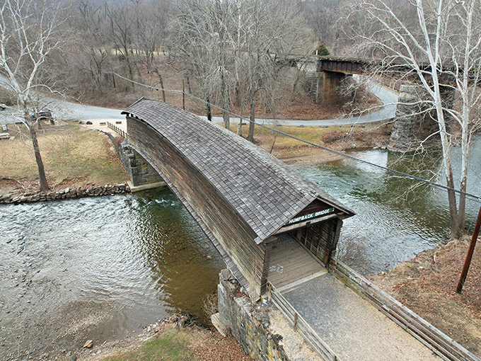 Winter reveals the bridge's elegant lines. Without summer's leafy distractions, you can fully appreciate this wooden masterpiece's graceful arch.