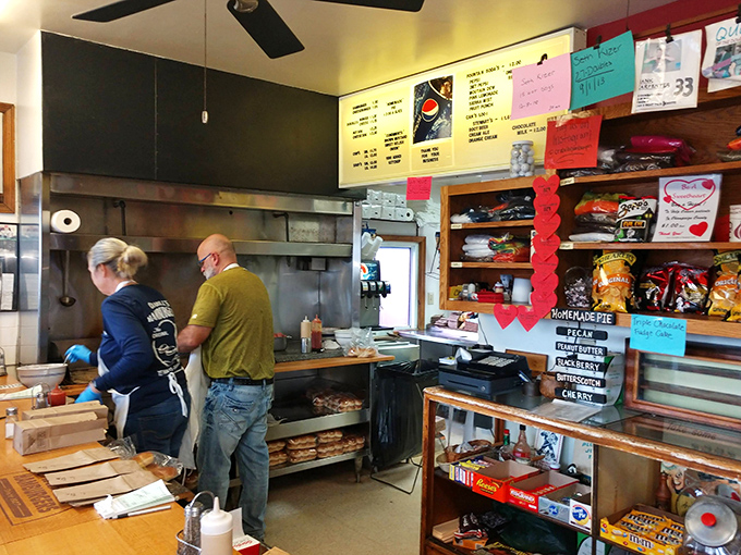 Where burger magic happens. Two skilled hands working in tandem, creating edible joy that keeps Urbana residents coming back for generations.
