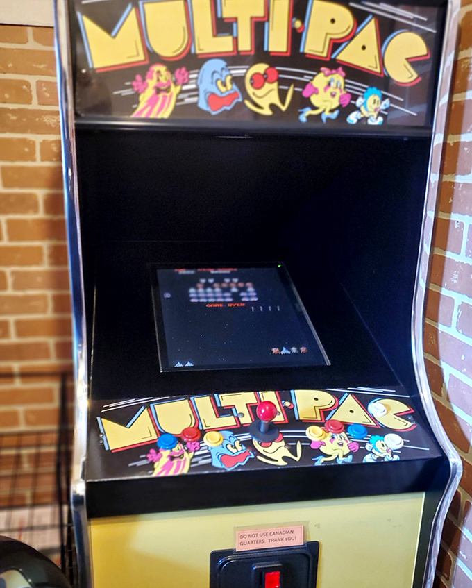 The vintage Ms. Pac-Man machine where kids have burned off pizza energy for decades. Some high scores here are older than the players.