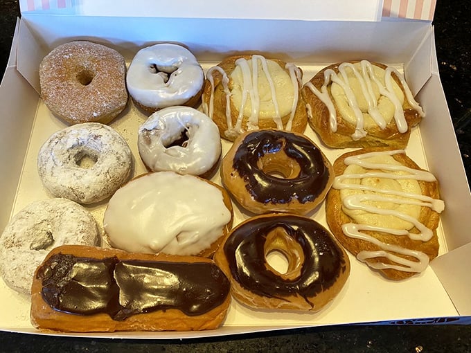 The ultimate donut box assortment – creating the perfect excuse to try "just a little piece" of everything while secretly plotting to grab that chocolate-frosted masterpiece.