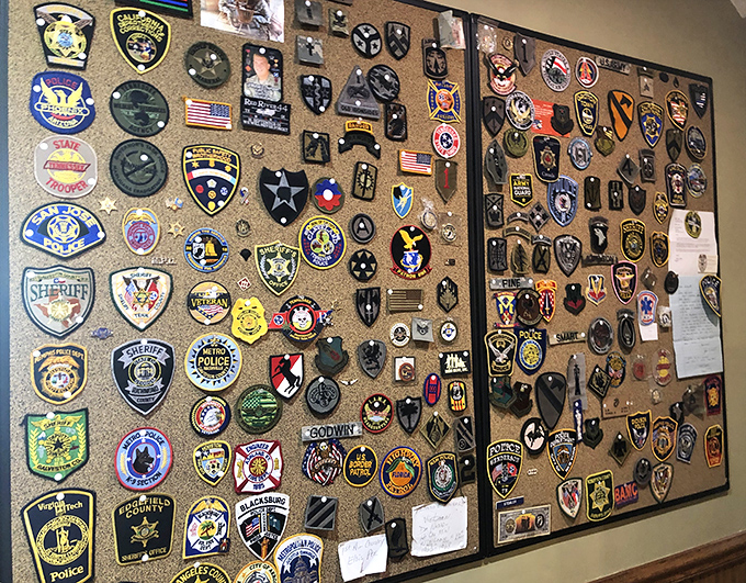 Military and law enforcement badges honor those who serve, creating a tribute wall that speaks to community pride and gratitude.