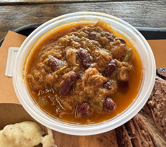 Baked beans swimming with chunks of meat&mdash;because at Wayne's, even the sides refuse to be vegetarian.