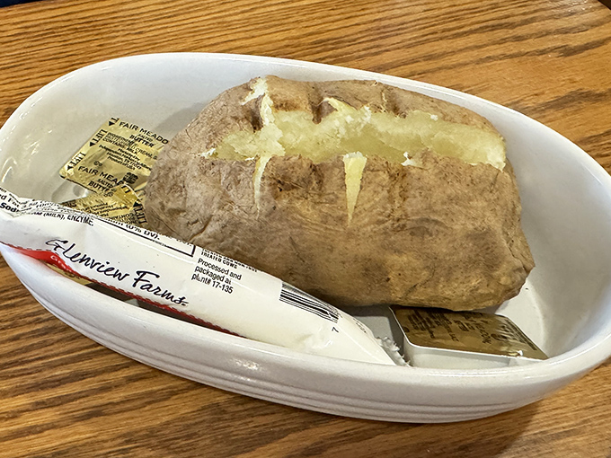The humble baked potato, elevated to main character status&mdash;fluffy interior, sturdy skin, waiting patiently for its butter to melt into every crevice. 