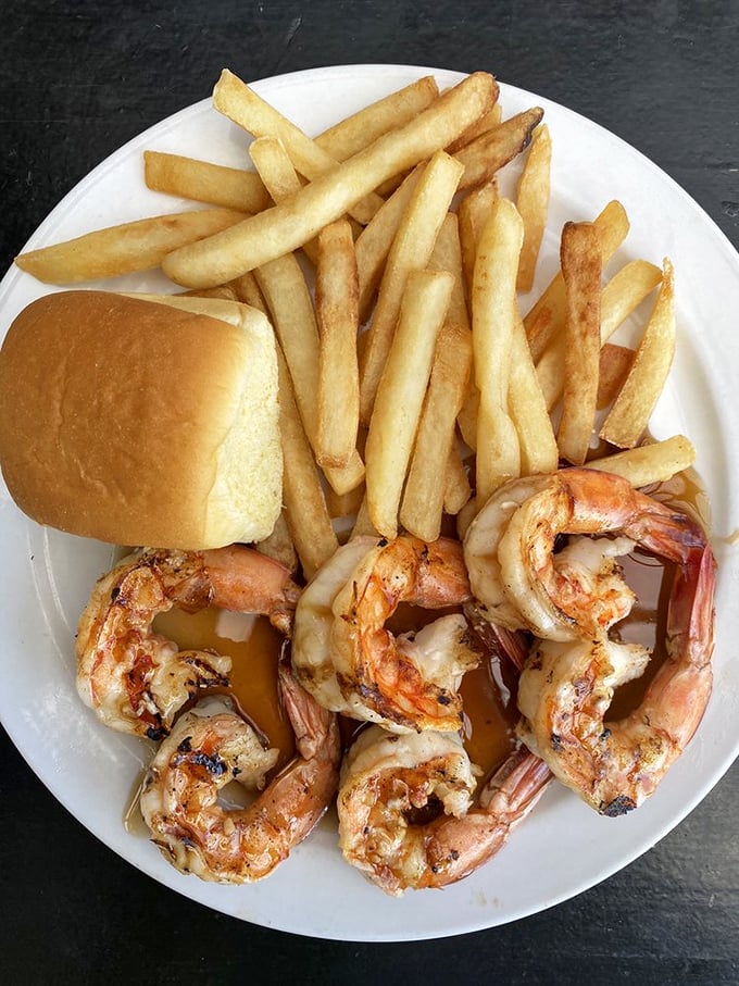 Perfectly grilled shrimp with fries and a roll&mdash;simple food done right, proving that sometimes the straightforward approach wins the race.