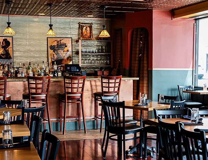 The bar area glows with warm light and possibility. Those pendant lamps cast the kind of flattering light that makes everyone look like they're in a food commercial.