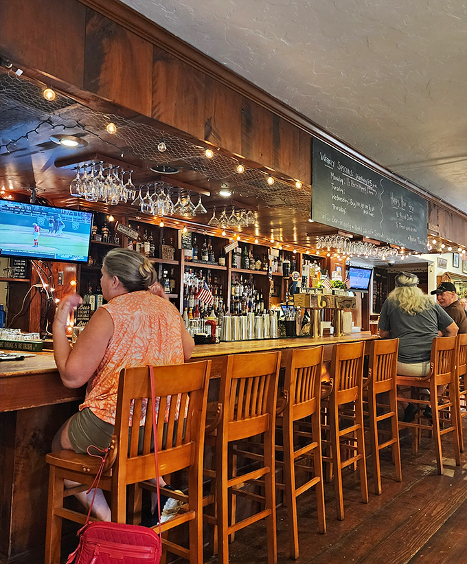 The bar's string lights and hanging glassware create that magical ambiance where even a simple pint feels like a special occasion.