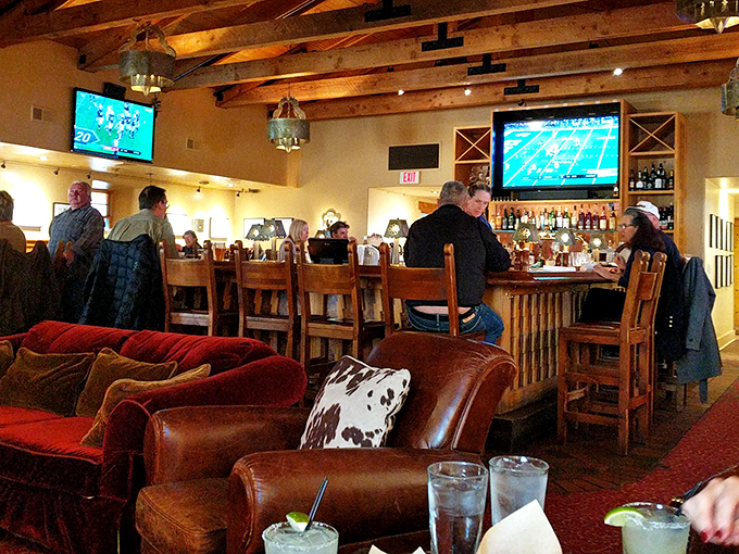The bar area where sports on TV never outshine the real main event: conversations that flow as smoothly as the cocktails being crafted.