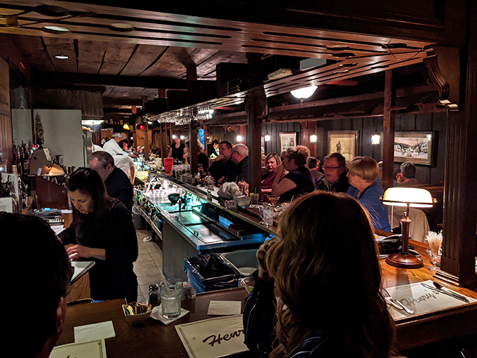 The bar area buzzes with anticipation as patrons perch like seagulls, eager for their next seafood treasure.