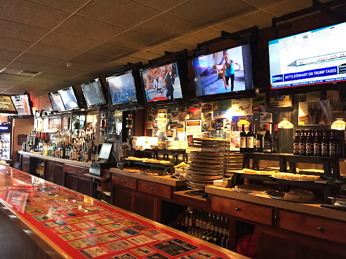 The bar area where sports fans become family and strangers become friends. Those TV screens have witnessed countless victories, defeats, and "did you see that?" moments.