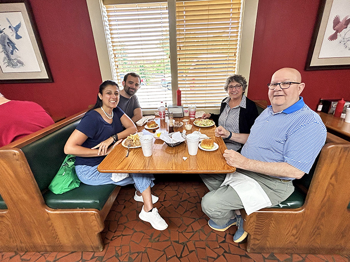Family booths where barbecue traditions pass from one generation to the next. These tables have hosted more celebrations than most wedding venues.