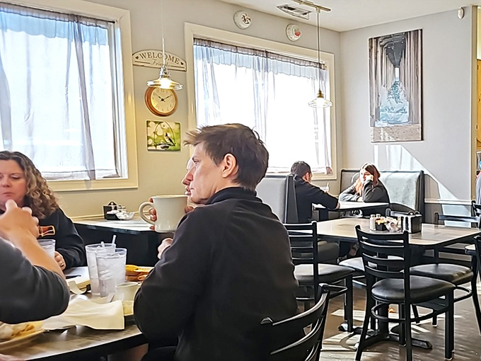 Bright windows flood the dining area with natural light. The "Welcome" sign isn't necessary&mdash;the atmosphere already said it.