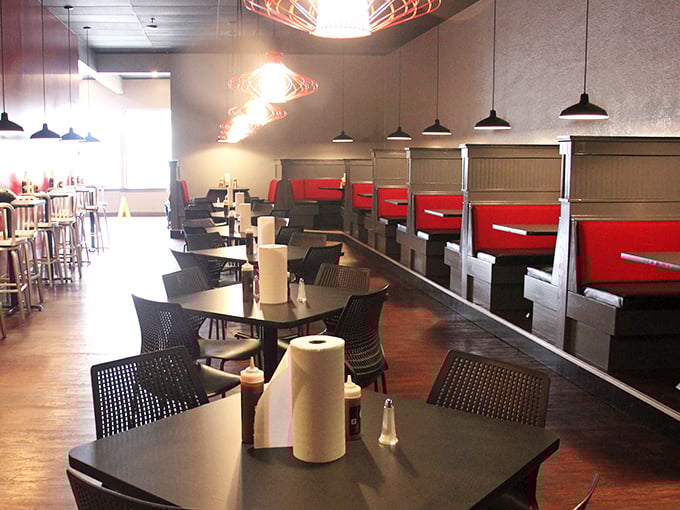 Booth seating with red accents invites you to settle in and take your time with every last bite.