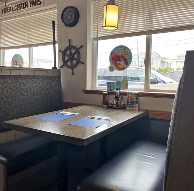 Ship's wheels and wooden accents transform simple booth seating into a captain's quarters where seafood feasts await lucky diners.