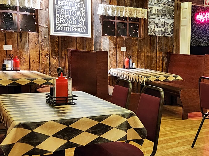 The classic diner setup with checkered tablecloths and squeeze bottles of ketchup creates that perfect nostalgic backdrop for serious sandwich business.
