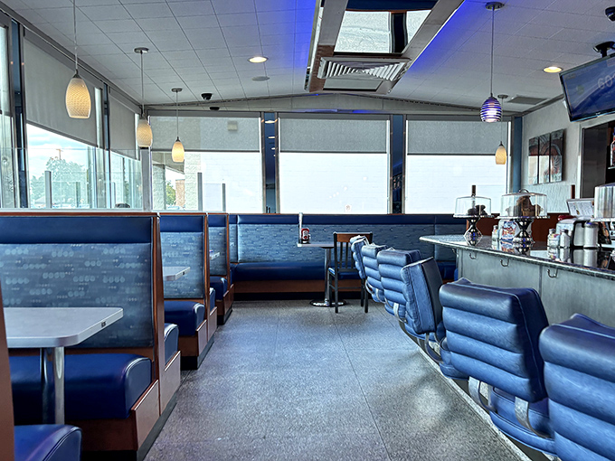 Empty booths waiting for the next rush of hungry patrons. The blue vinyl and pendant lighting create that timeless diner aesthetic.