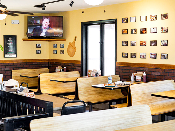 Classic booth seating where countless pizza memories have been made&mdash;beneath walls that tell the story of a beloved local institution.
