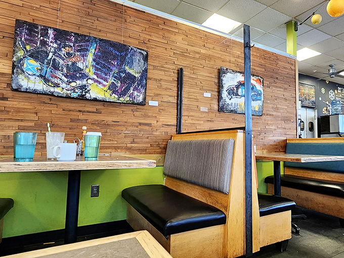 Wooden booths backed by slat walls and local artwork create the perfect backdrop for morning conversations that stretch into afternoon without anyone noticing the time.
