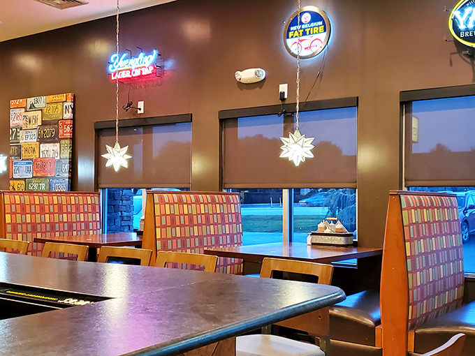 Colorful booth seating beneath neon beer signs &ndash; where the serious business of barbecue consumption happens in surprisingly comfortable surroundings.