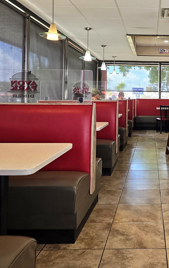 Red booths lined up like faithful soldiers, ready to cradle you through breakfast decisions of monumental importance.