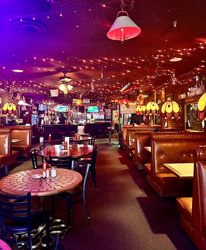 After dark, the dining room transforms into a twinkling wonderland where Tiffany lamps cast their glow over vinyl booths that have cradled Portland's hungry souls for decades.