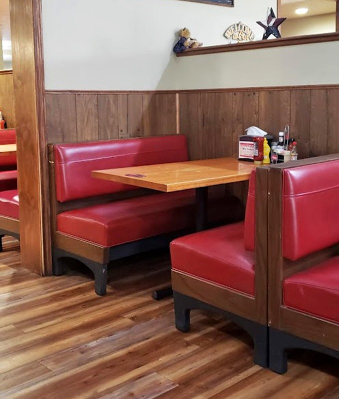 Classic diner booths with those unmistakable red vinyl seats&mdash;the kind that have witnessed countless conversations, confessions, and comfort food moments.