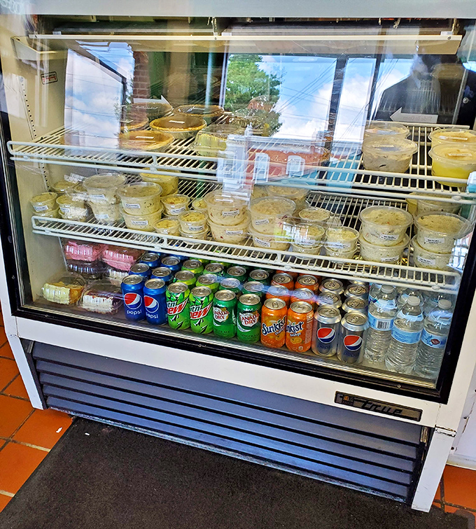 A refrigerator case stocked with sides and drinks—the supporting cast to the star of the show. Every great meal needs its ensemble.