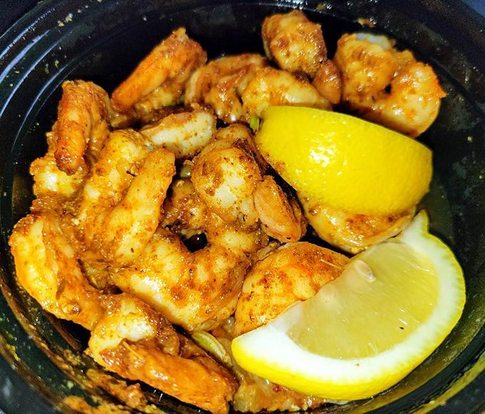 These shrimp aren't just seasoned—they're educated in the school of Cajun flavor. The lemon wedges stand by, ready to brighten every perfect bite.