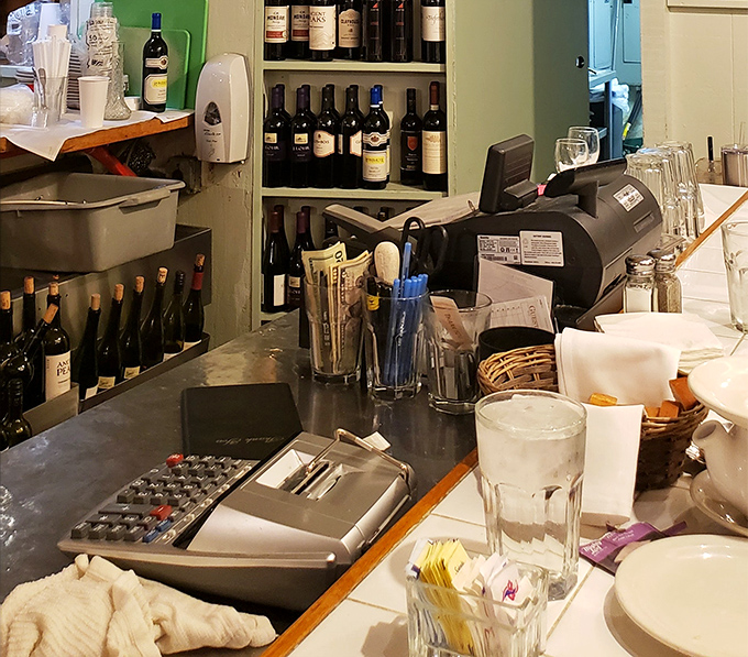 Behind every great seafood restaurant is a well-organized cashier station and enough wine bottles to survive a minor apocalypse.