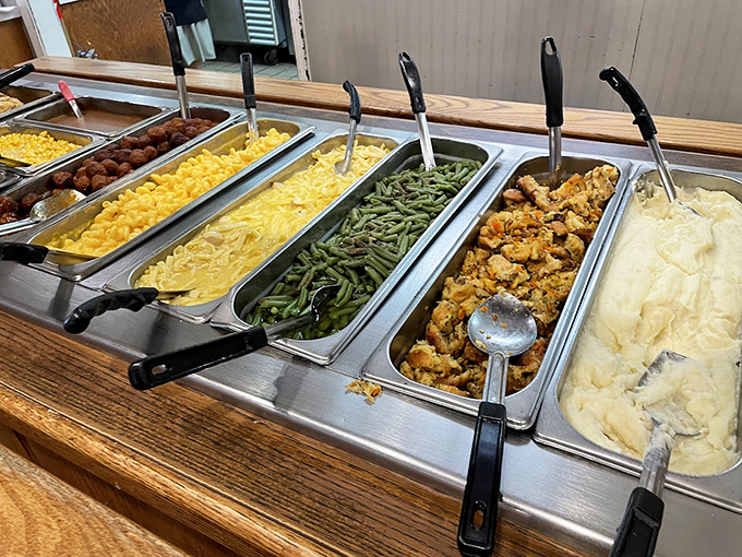 The buffet line stretches with mashed potatoes, green beans, dressing, and corn, basically challenging your self-control to a duel.