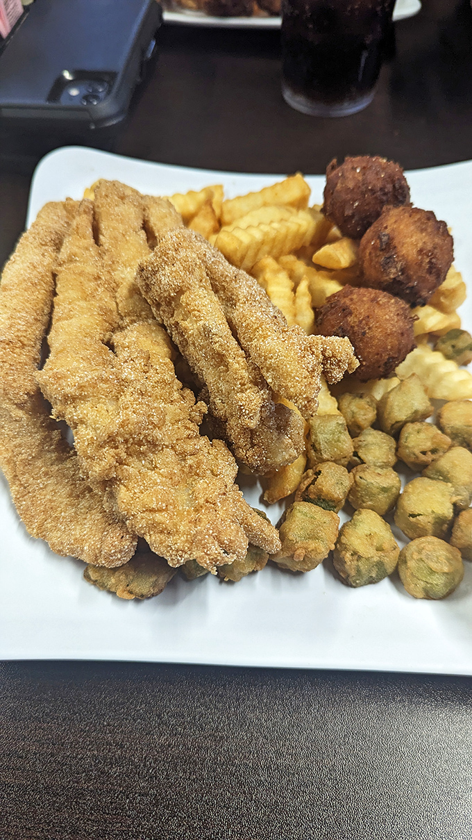 Southern fried catfish with a cornmeal crust that crackles with each bite. Those hushpuppies aren't just sides &ndash; they're little spheres of cornbread joy.