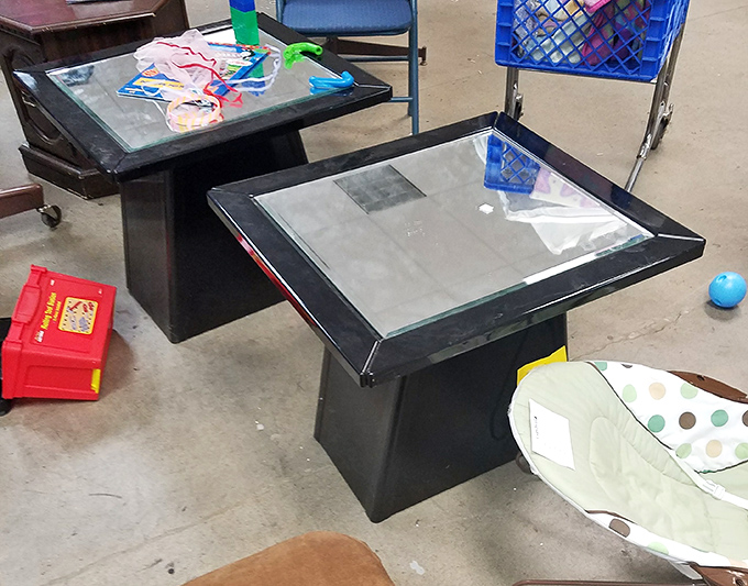 Glass-topped tables stand ready for adoption, waiting to become the conversation piece in someone's first apartment.