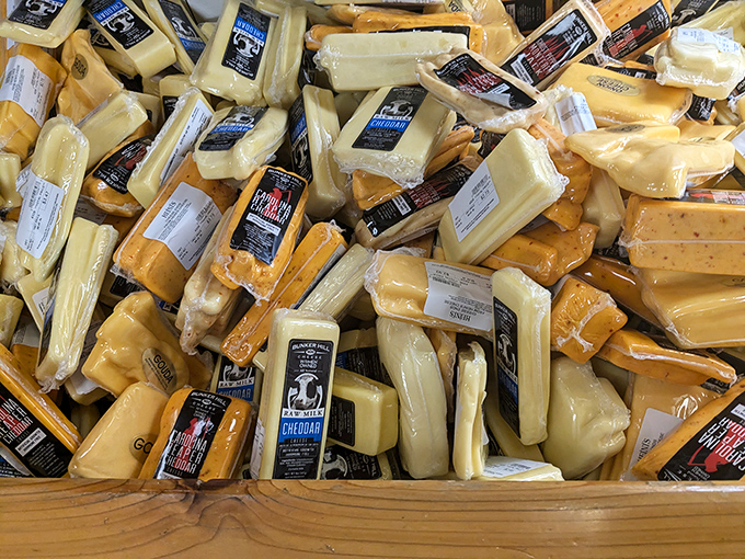 A cheese display that would make Wisconsin jealous—golden blocks and wedges piled high like a dairy-lover's version of Fort Knox.