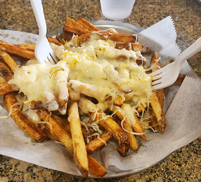 Fries transformed from side dish to main event, where cheese blankets crispy potatoes in a gooey embrace that makes sharing nearly impossible.