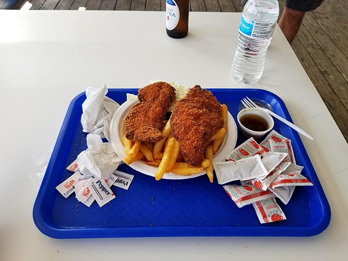 Sometimes even seafood lovers need a break—this perfectly golden chicken sandwich with crispy fries offers a delicious mainland alternative.