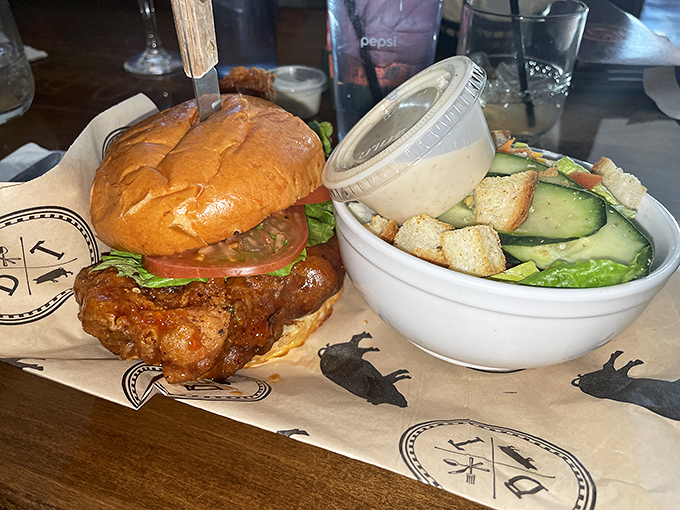 This chicken sandwich means business&mdash;crispy, saucy, and served with a side salad for those pretending to make healthy choices.