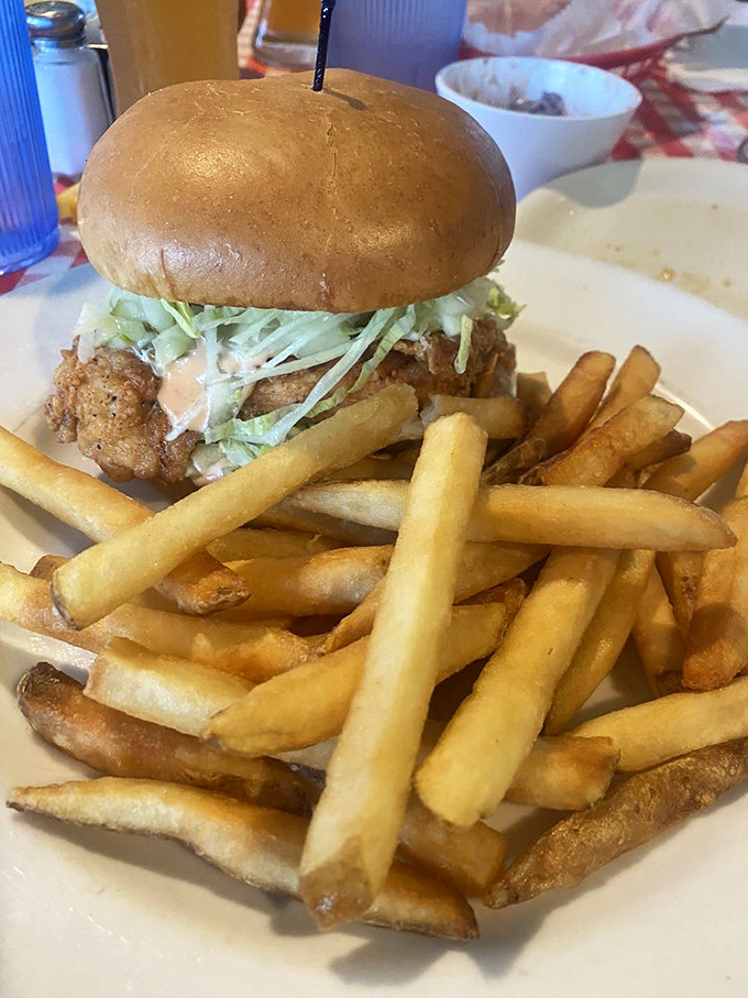 This isn't just a sandwich; it's architecture with purpose. The crispy chicken and fresh slaw create a skyscraper of flavor that towers over those perfectly golden fries.