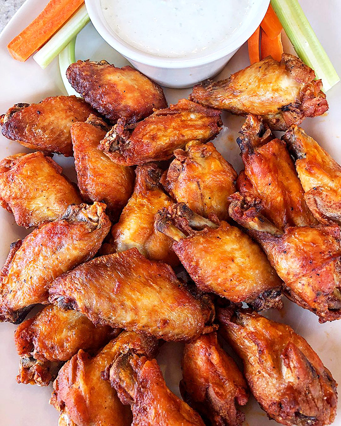 Wings that make you question why we ever relegated chicken to breakfast sausage status. These crispy beauties deserve their own fan club.