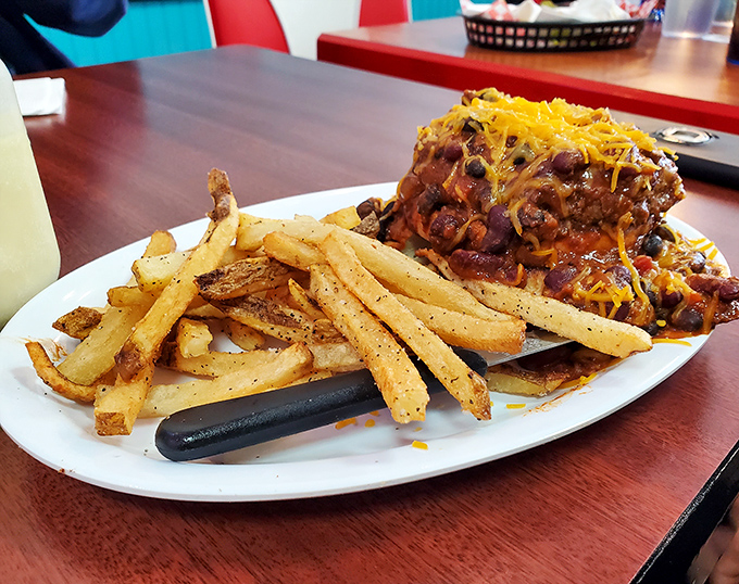 Chili so good it needed reinforcements&mdash;cheese, fries, and a fork for the brave. This isn't a meal; it's a delicious commitment.