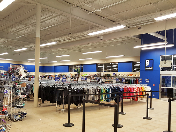 The main shopping floor, where the signature Goodwill blue walls frame a retail experience more akin to a treasure hunt than conventional shopping.