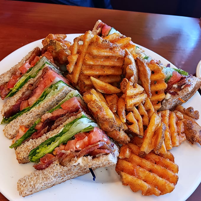 A club sandwich that's clearly overachieving, with waffle fries that refused to be ordinary &ndash; lunch making its case for attention.