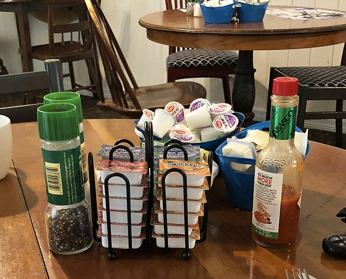 The condiment caddy&mdash;breakfast's unsung hero&mdash;stands ready with jellies, hot sauce, and pepper, the supporting cast to your morning's main event.