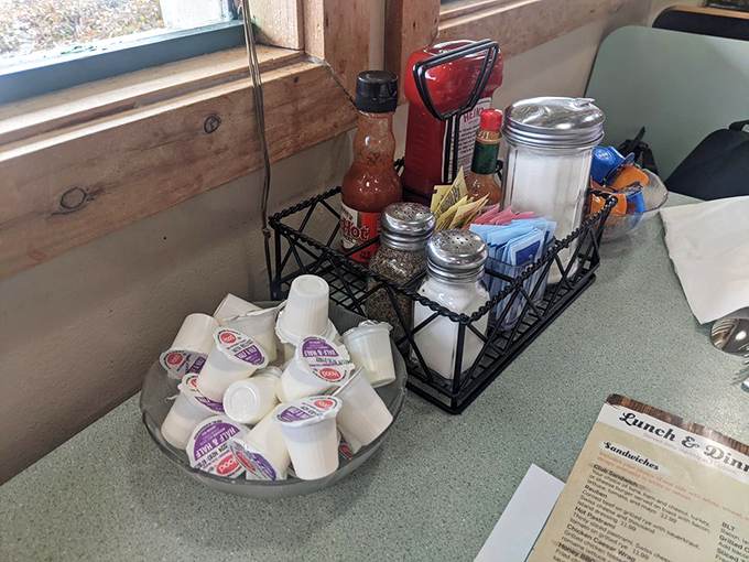 The condiment station stands ready like a tiny army of flavor reinforcements.