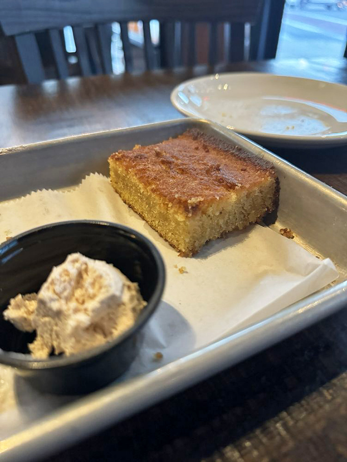 Cornbread that strikes the perfect balance between sweet and savory, with a side of whipped butter that melts into each warm, golden square.