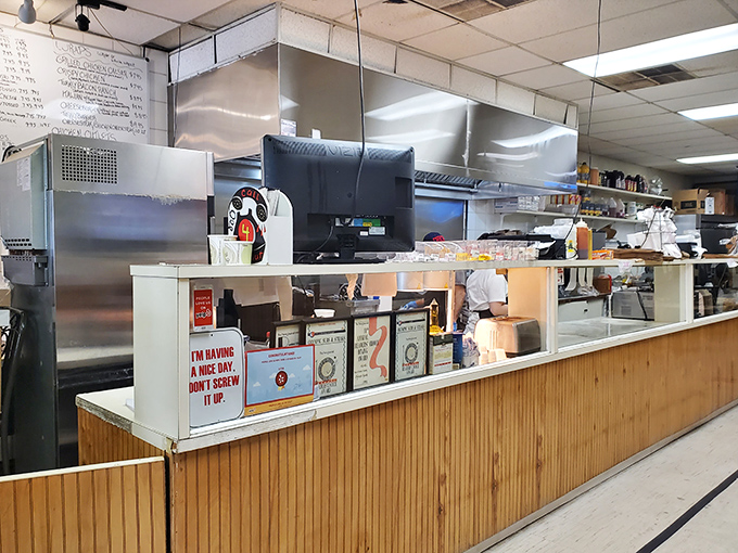 At the counter, where sandwich dreams become reality, a sign warns: "I'm having a nice day, don't screw it up." Fair enough!