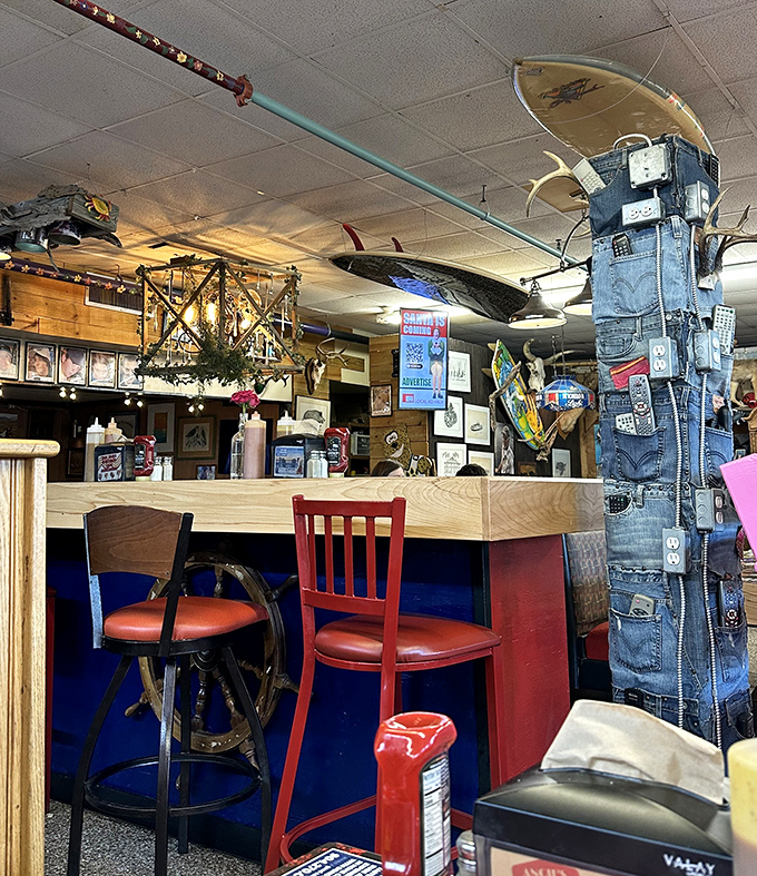 Mismatched chairs in red and wood surround counters where sandwich magic happens. The denim pillar might be the most Florida decoration ever.