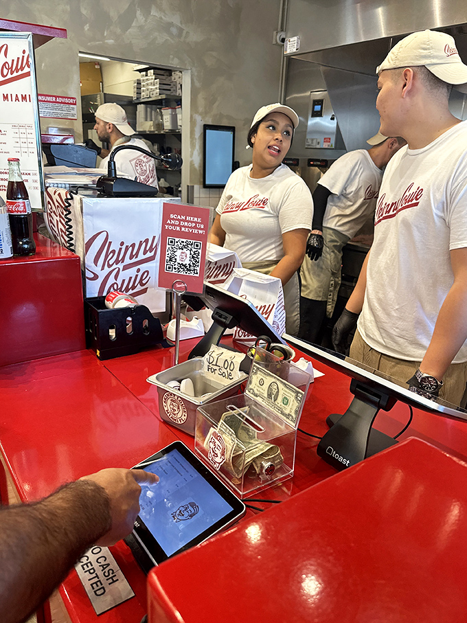 At the counter, where burger dreams become reality and friendly staff guide you through the delicious decision-making process.